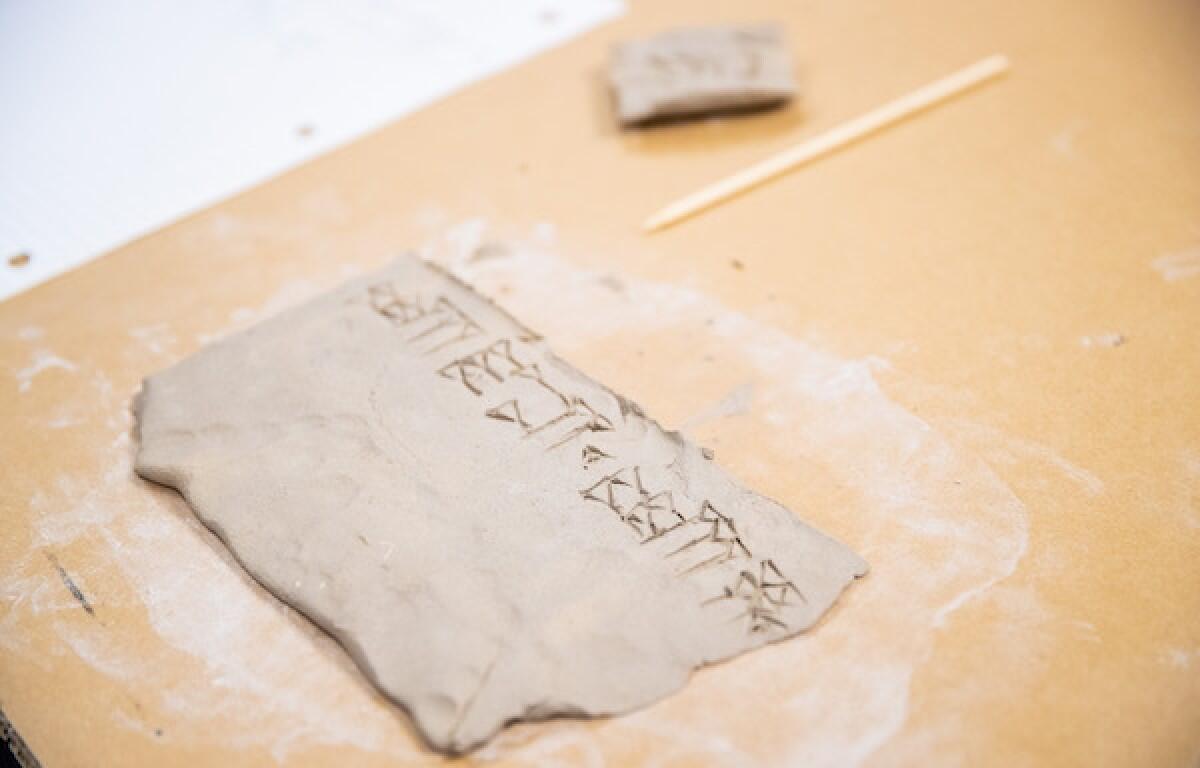 APSU honors students create clay tablets for history of the book class ...
